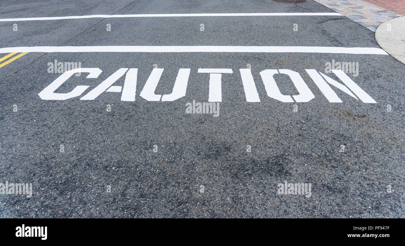 Caution sign and line painted on the street Stock Photo - Alamy