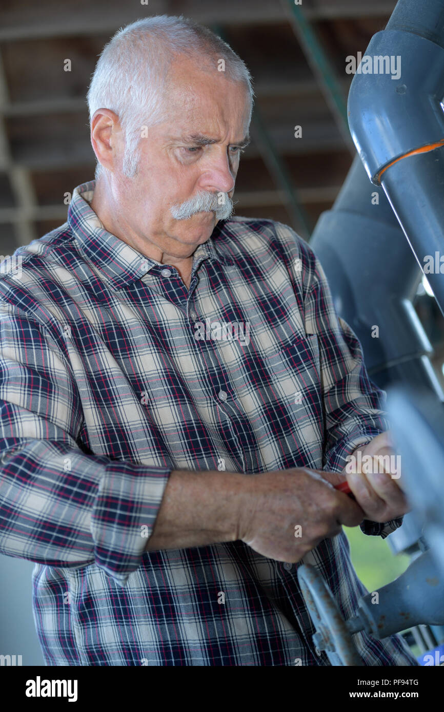 senior worker with valve Stock Photo - Alamy