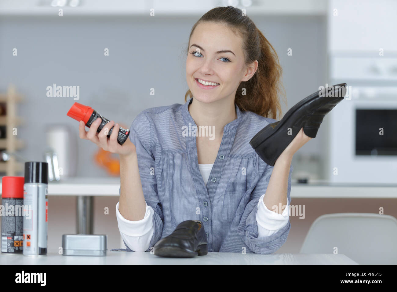 happy young female cleaning shoes Stock Photo - Alamy