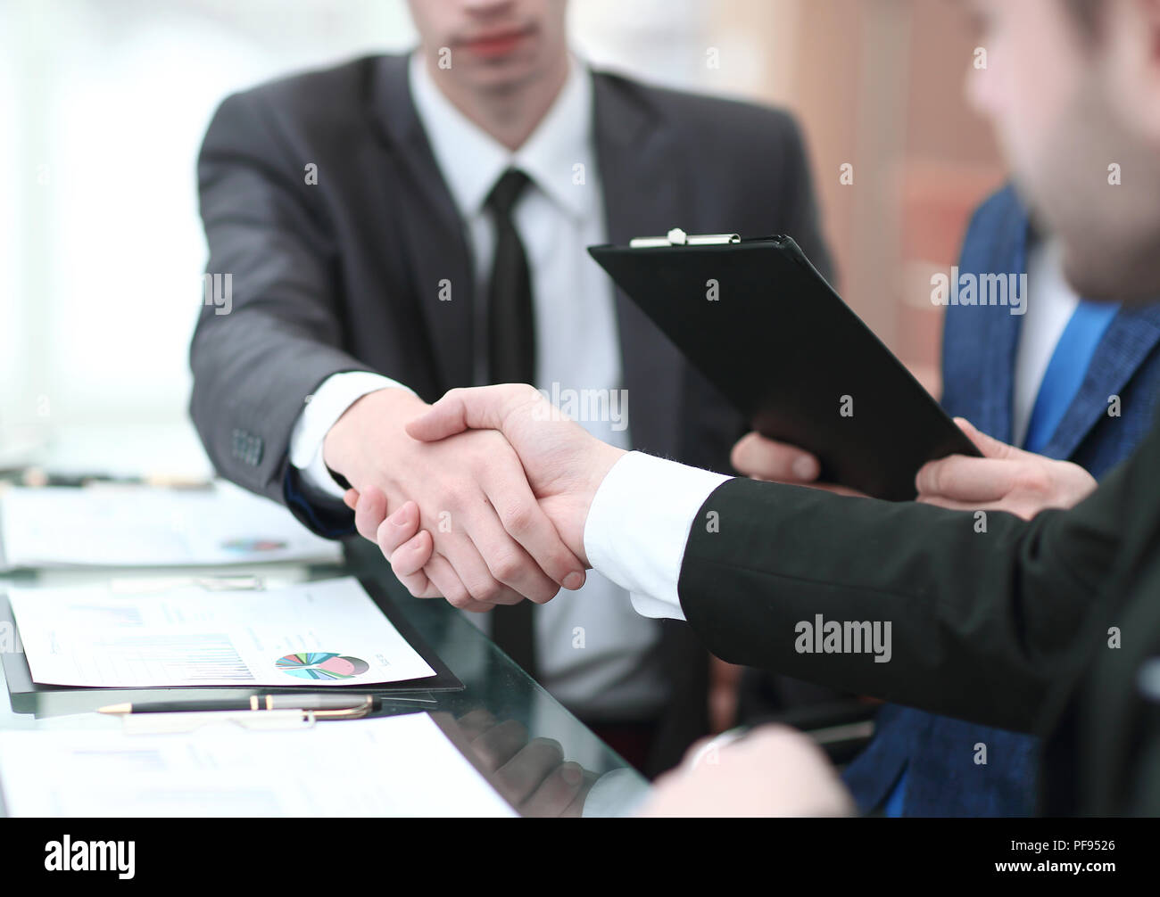 handshake of financial partners at the Desk Stock Photo - Alamy