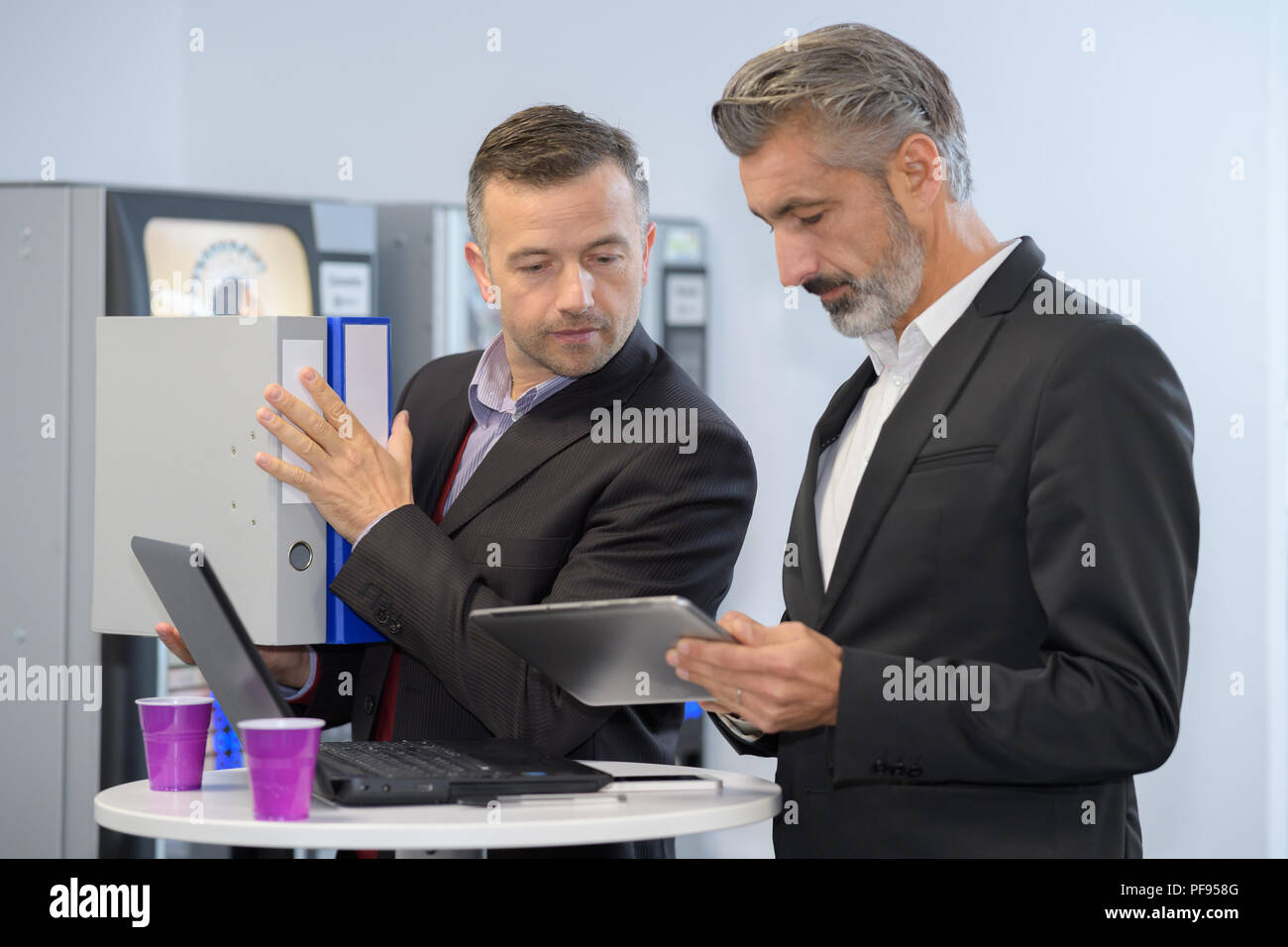 business people with technology while discussing at office Stock Photo ...