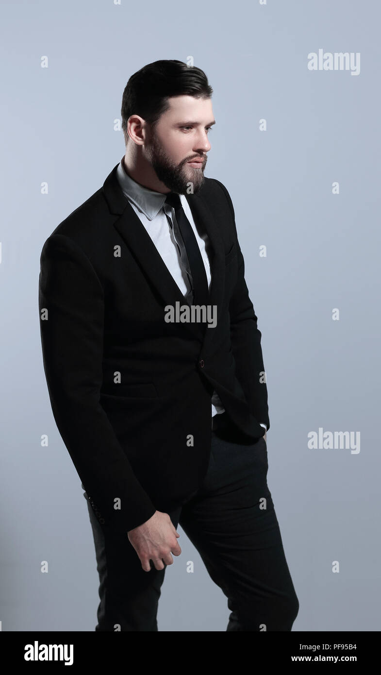 side view.portrait of a serious businessman.isolated on grey background ...