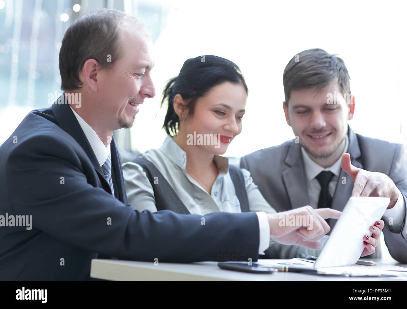 Business team using tablet touchpad for meeting to discuss statistical ...