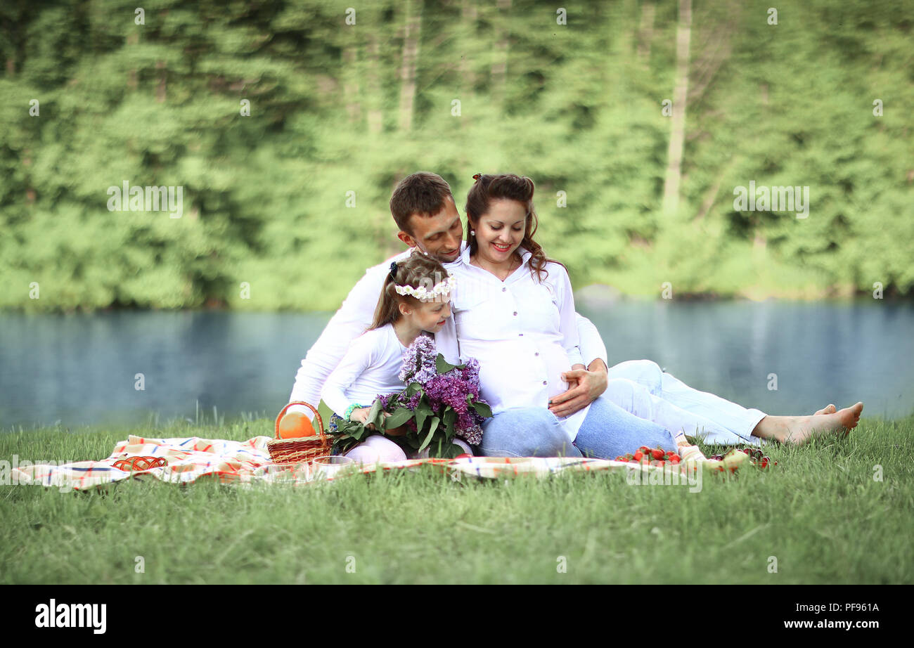 happy family: father,pregnant mother and little daughter on a pi Stock ...