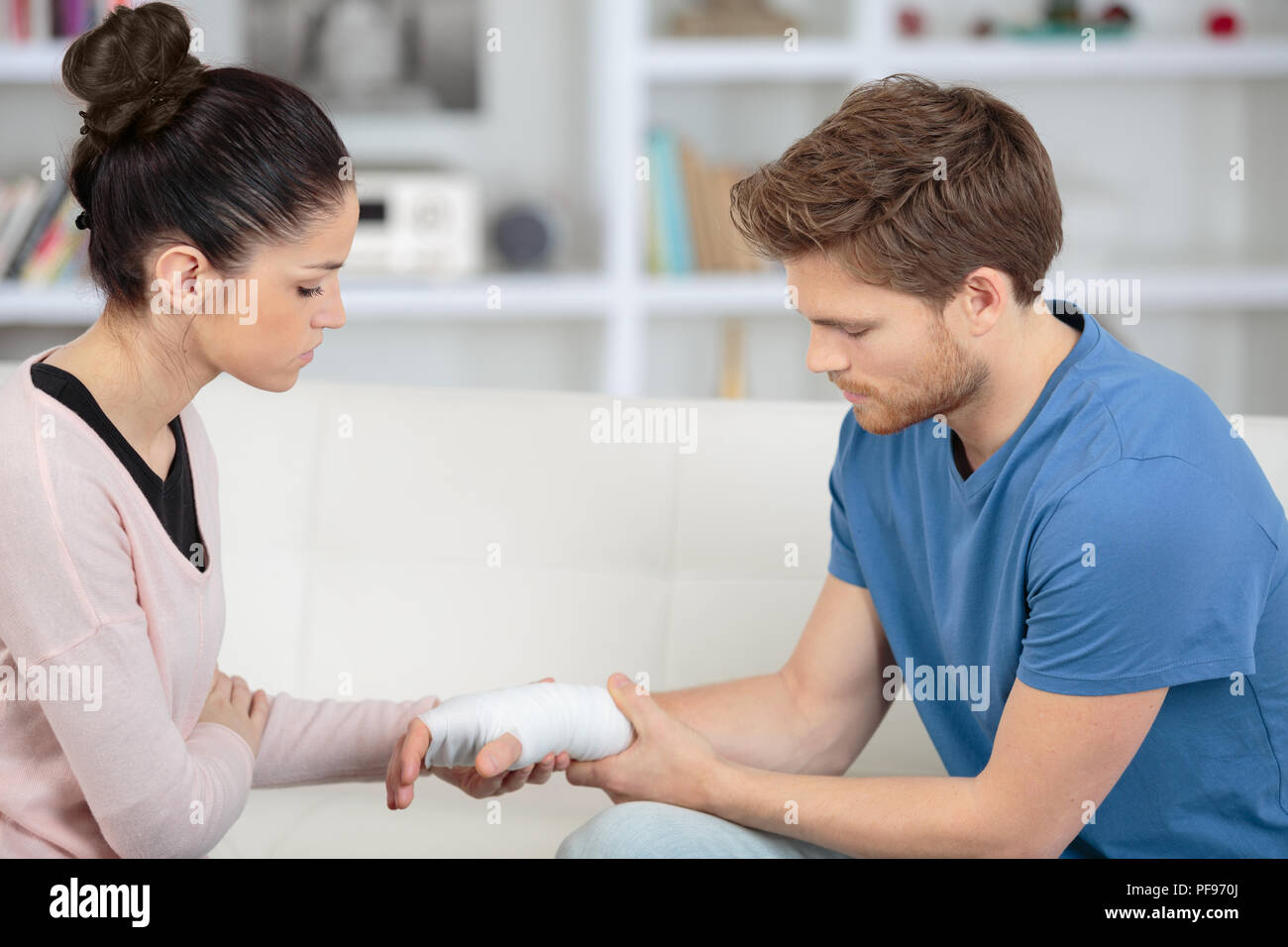 Man showing partner his bandaged hand Stock Photo - Alamy