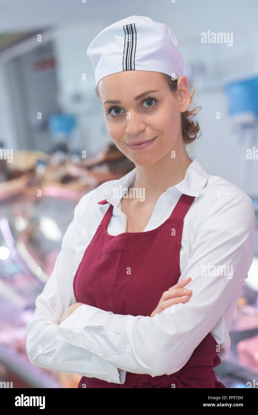 portrait of confident female butcher posing arms crossed Stock Photo ...