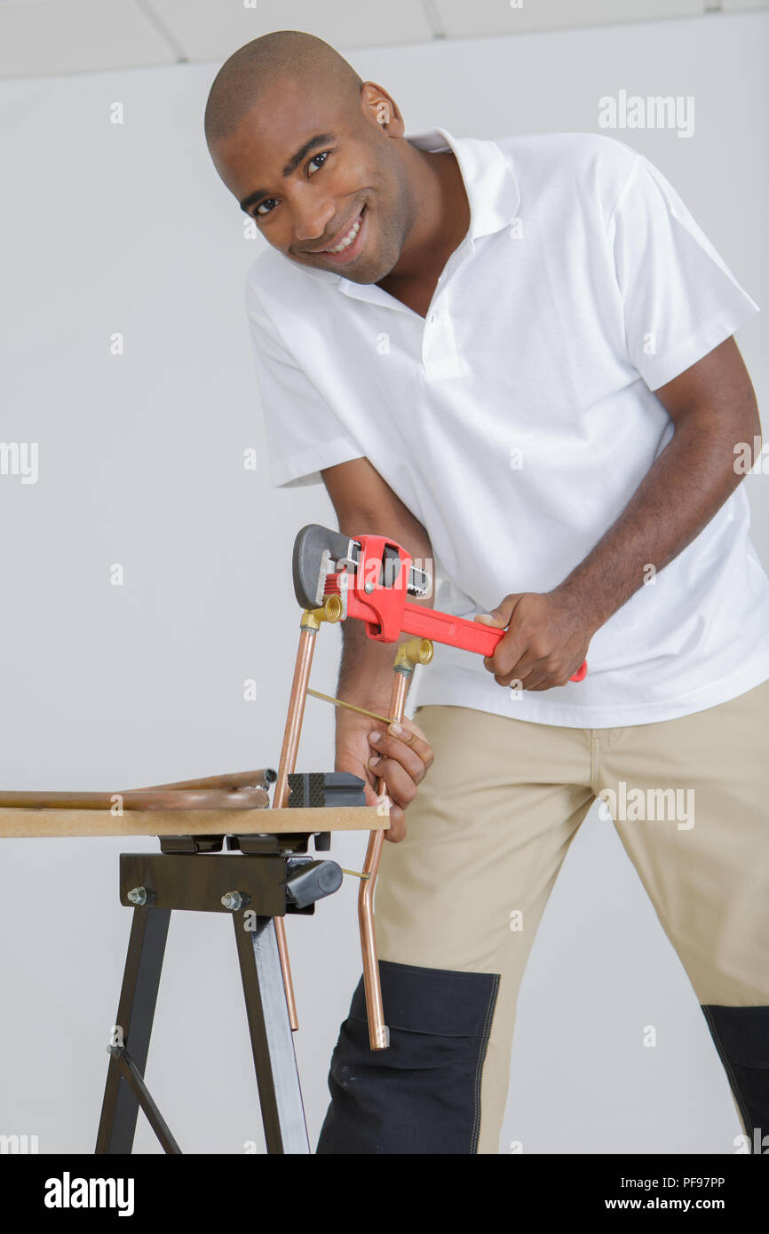 Man shaping copper pipe with adjustable wrench Stock Photo - Alamy