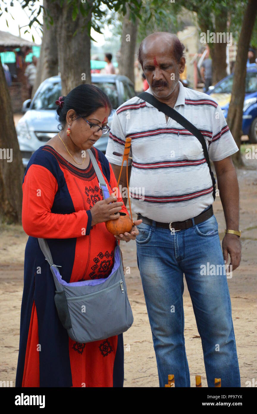 A couple choose toy Ektara or one string musical instrument at the ...