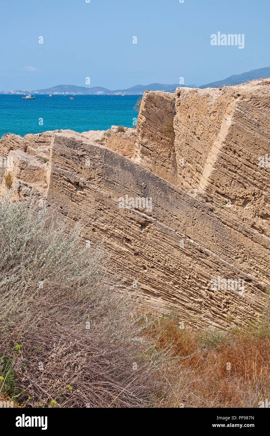 Natural coastal summer landscape with porous banded limestone rock and ...