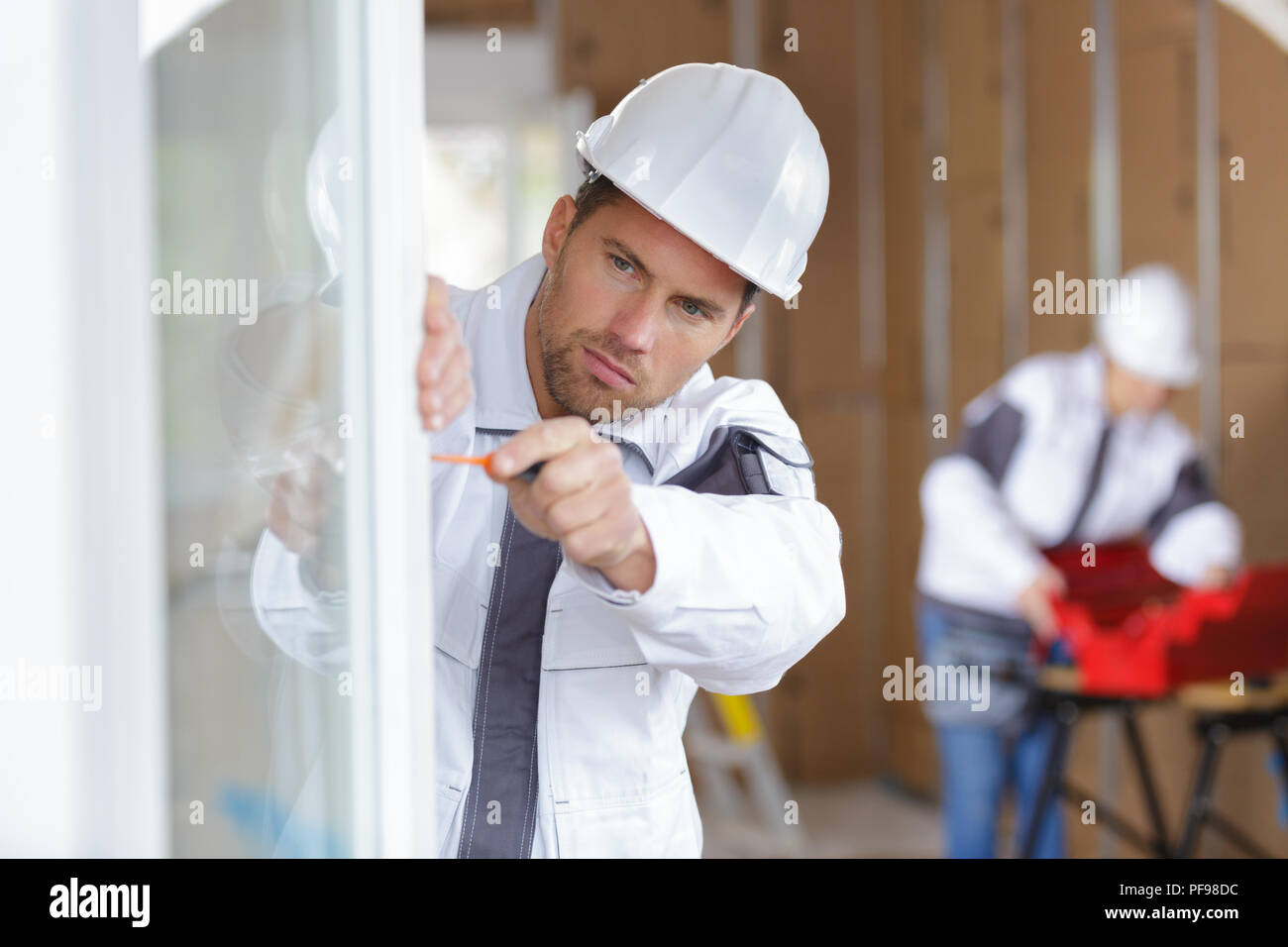 construction worker installing window in house Stock Photo - Alamy