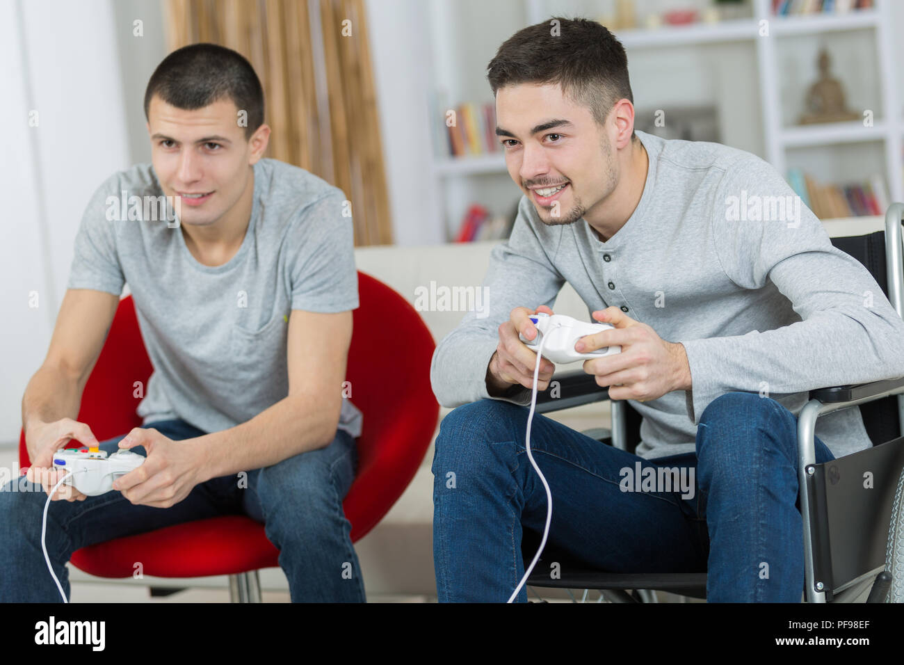 happy young brothers playing video games Stock Photo - Alamy