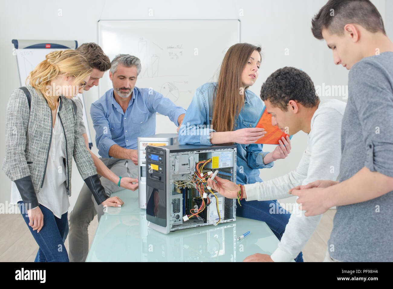 Young students around computer hi-res stock photography and images - Alamy