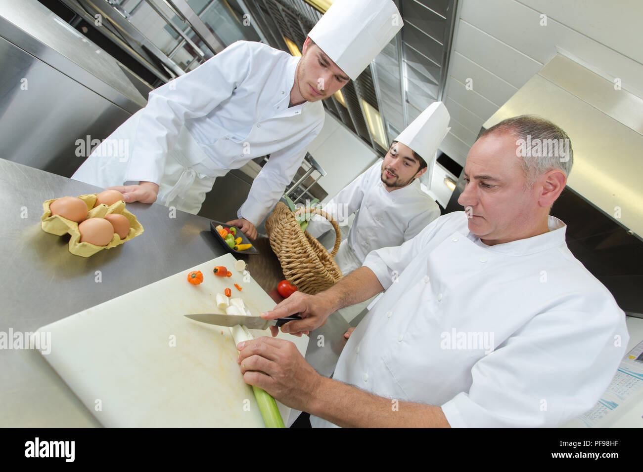 trainees watching chef prepare vegetables Stock Photo - Alamy