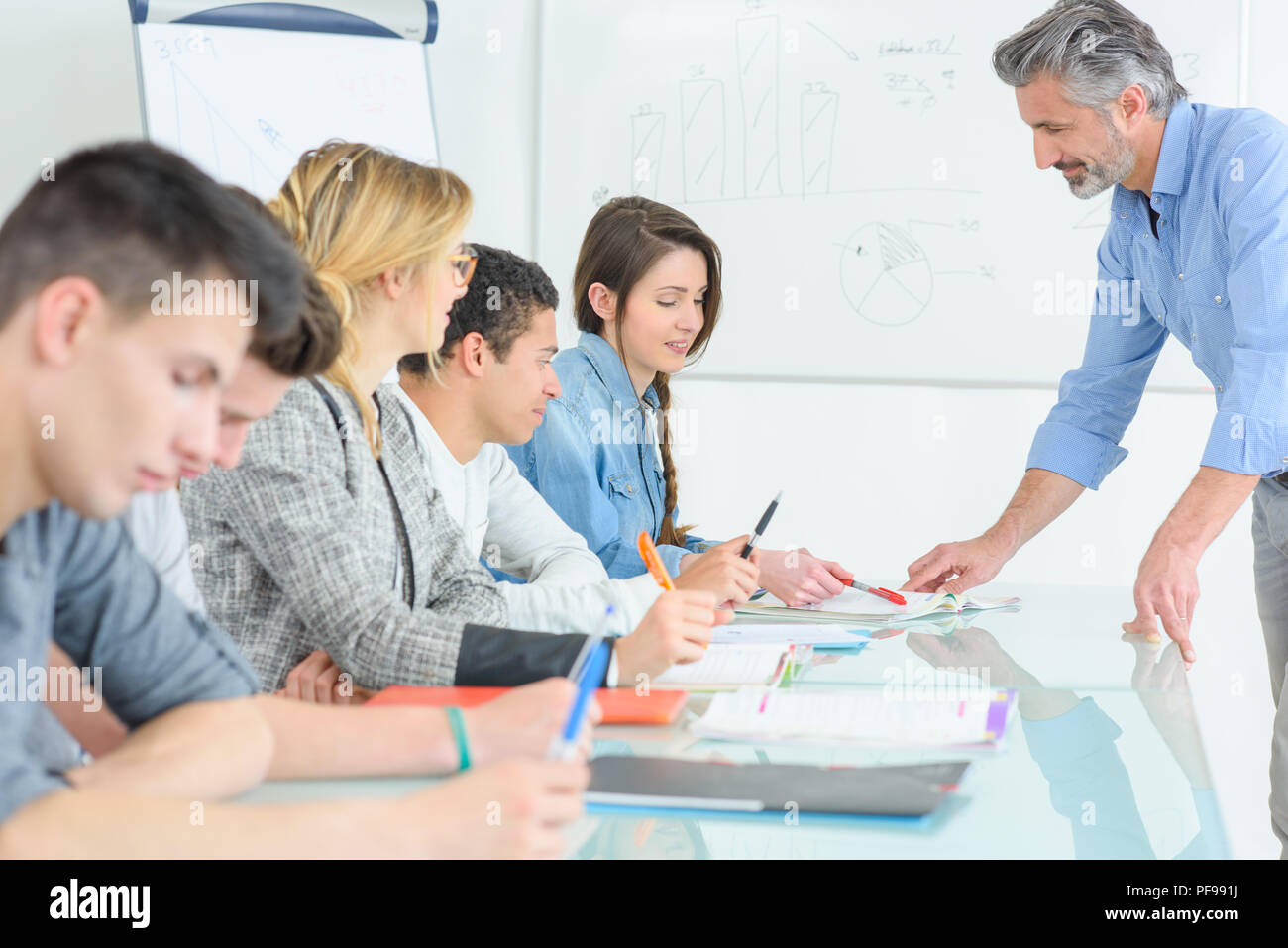 teacher and students in a classroom Stock Photo - Alamy