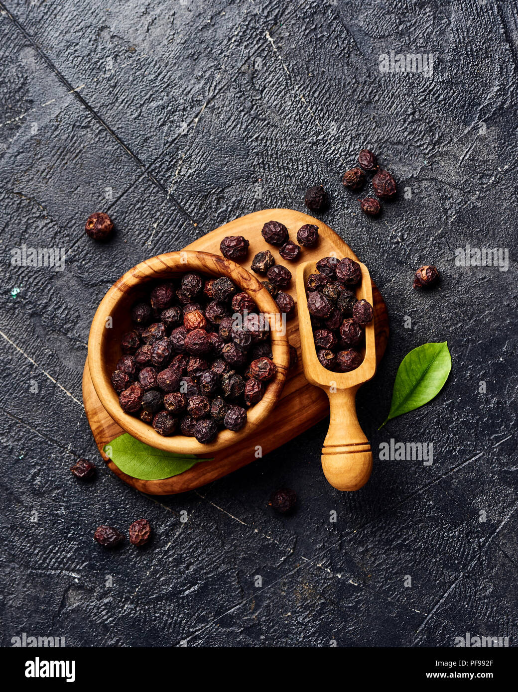 Dried hawthorn fruits on black background. Top view of Crataegi fructus ...