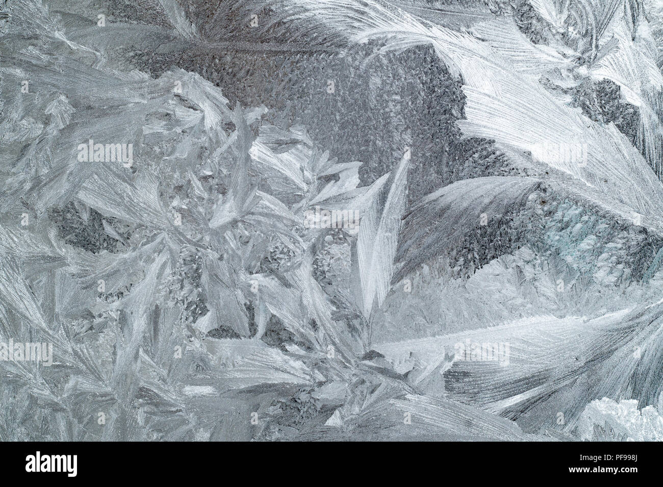 Frozen ice patterns on glass Stock Photo - Alamy