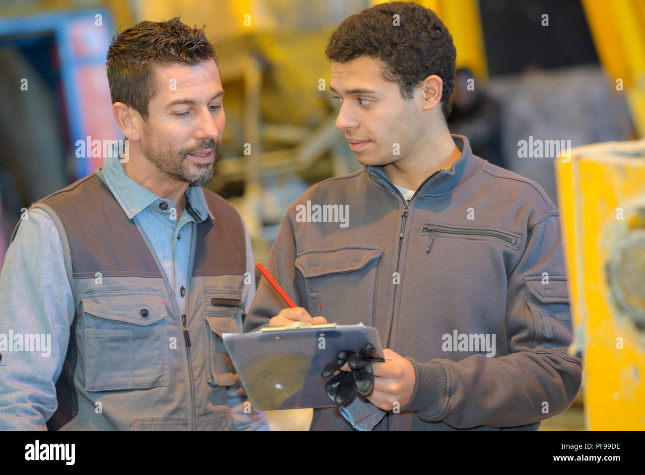 boss and worker together in a carpenters workshop Stock Photo - Alamy