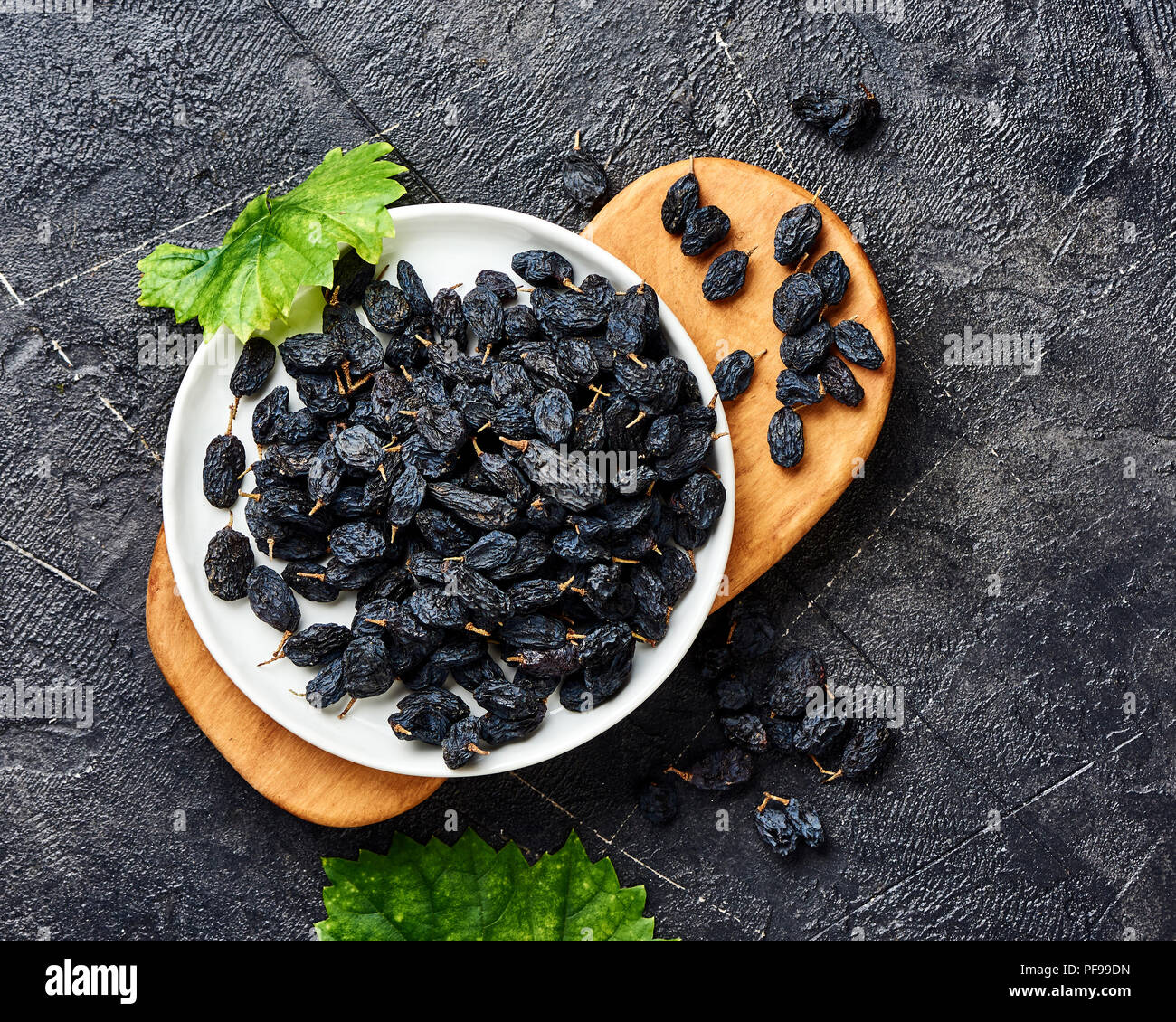 Black raisins on plate. Top view of dried grapes Stock Photo - Alamy