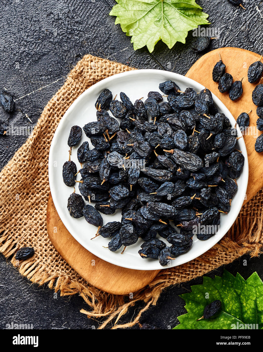 Black raisins on plate. Top view of dried grapes Stock Photo - Alamy