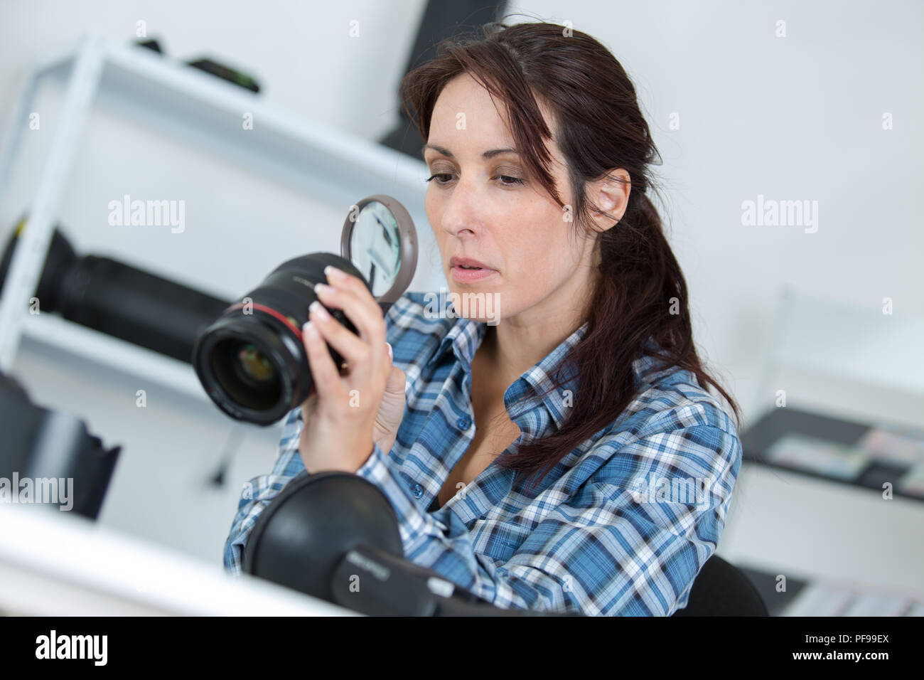 female photographer with magnifying glass Stock Photo - Alamy