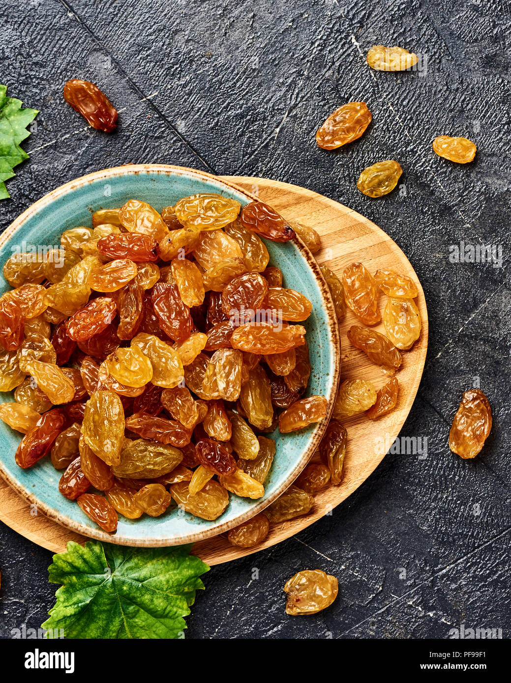 Yellow big raisins on black concrete background. Top view of dried ...