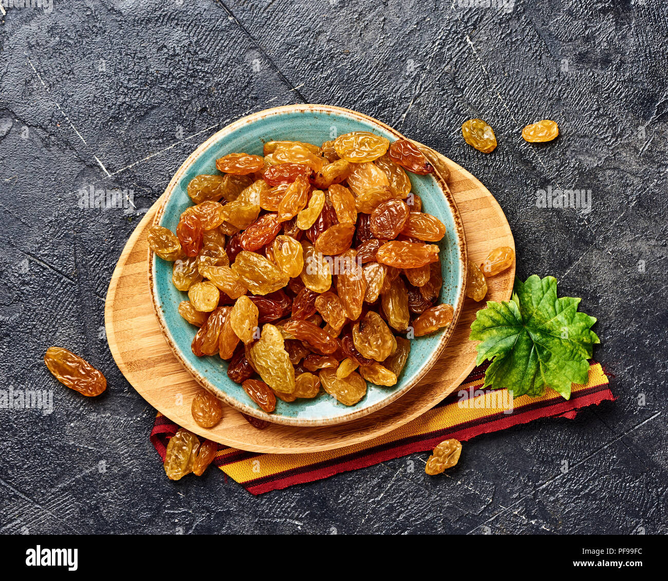 Yellow big raisins on black concrete background. Top view of dried ...