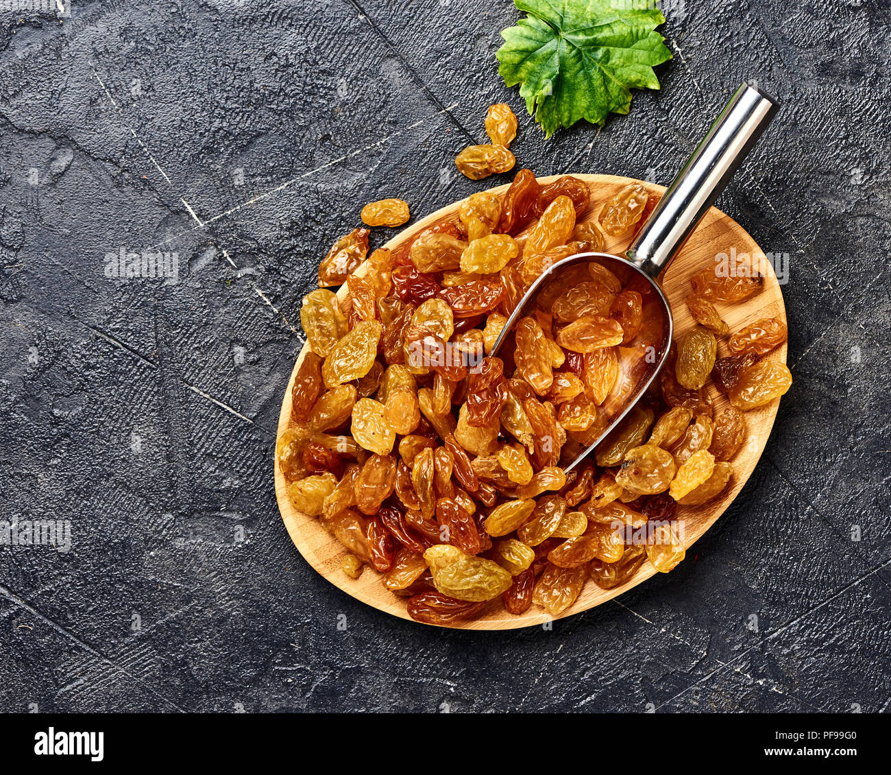 Yellow big raisins on black concrete background with copy space. Top ...