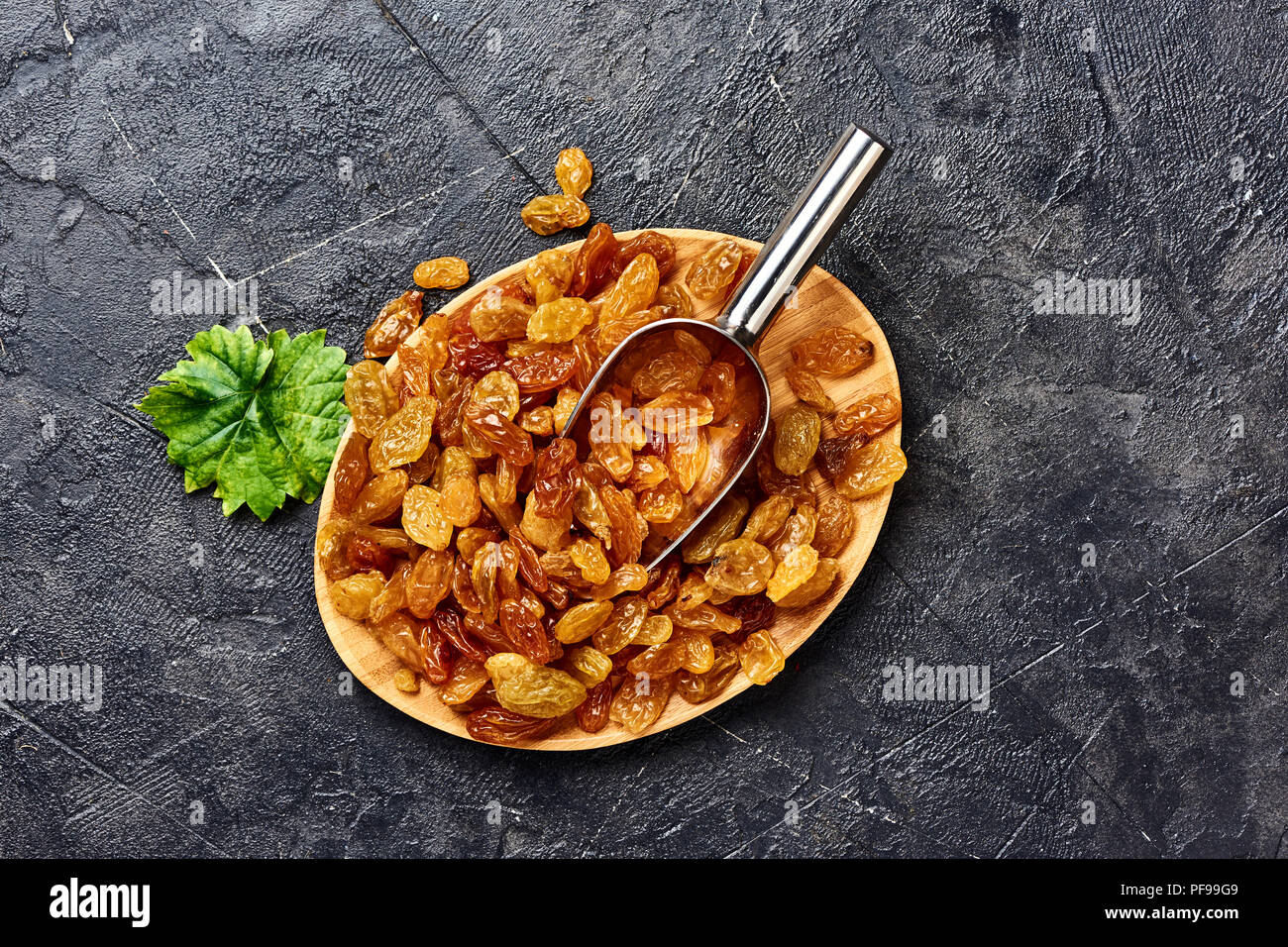 Yellow big raisins on black concrete background with copy space. Top ...