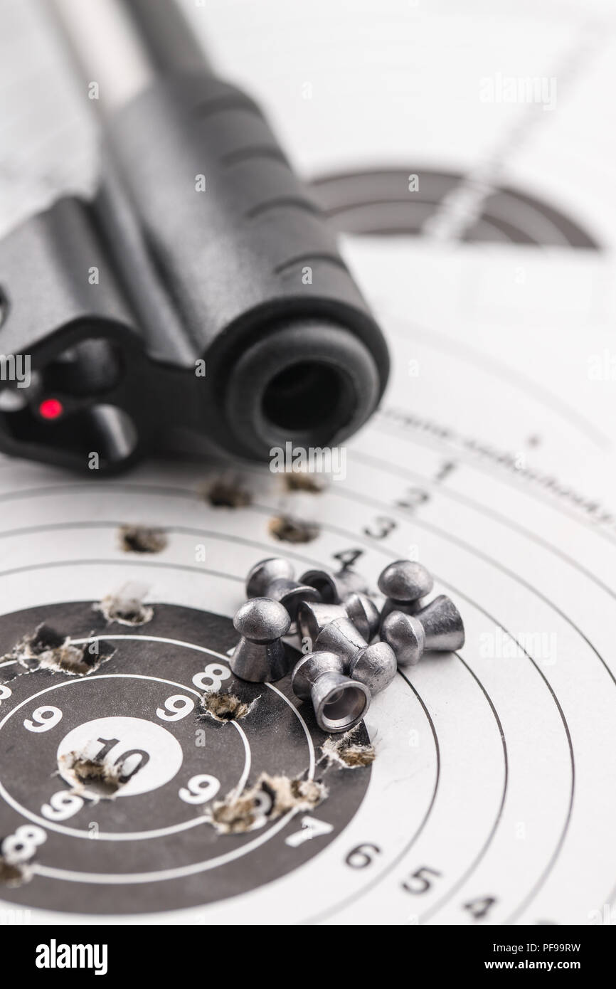 Lead airgun pellets on paper target Stock Photo - Alamy