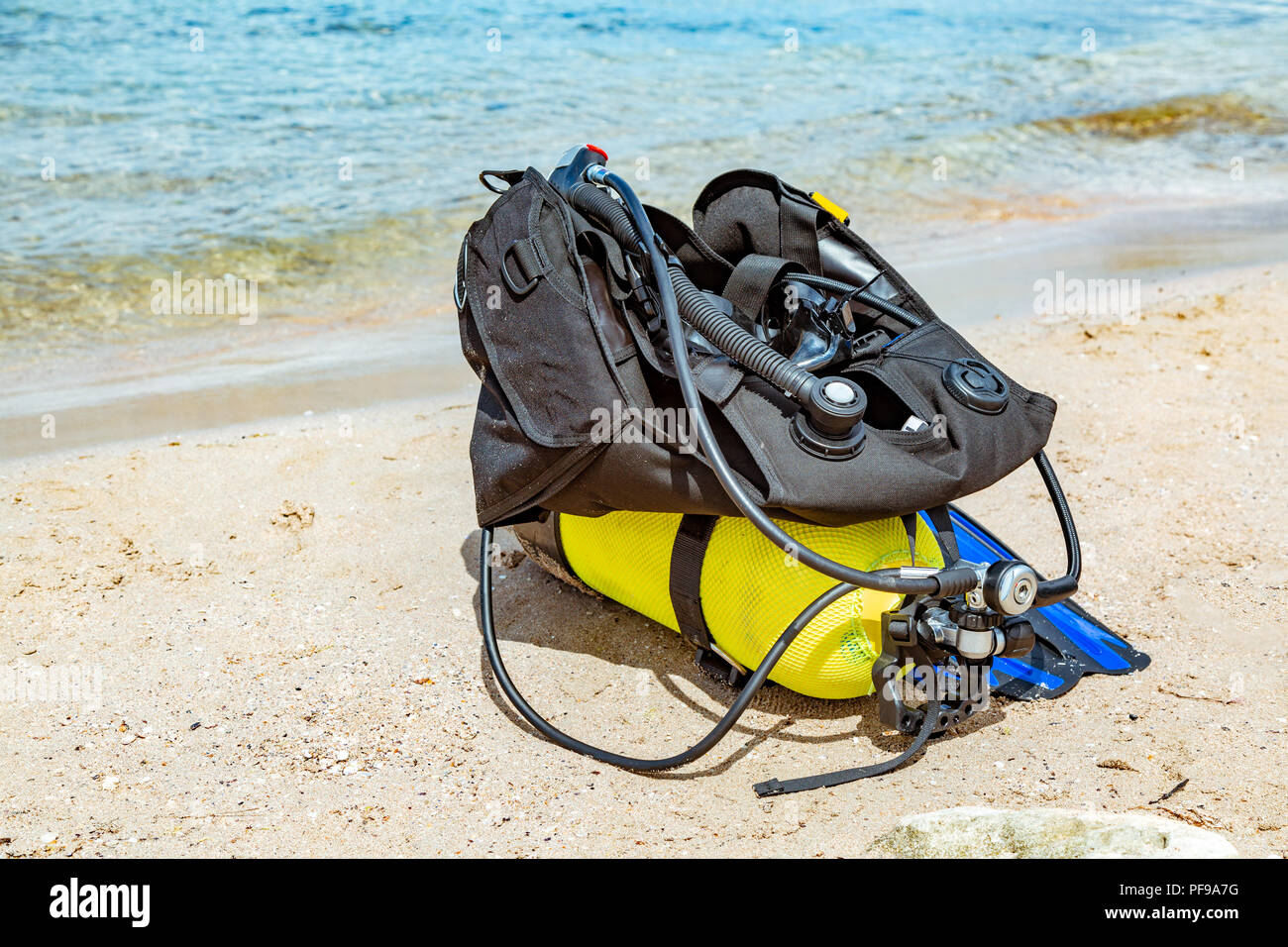 Equipment of a scuba diver, an oxygen balloon lies on the beach. Diving ...