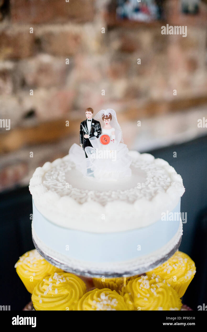Top tier of a traditional wedding cake with miniature bride and groom ...