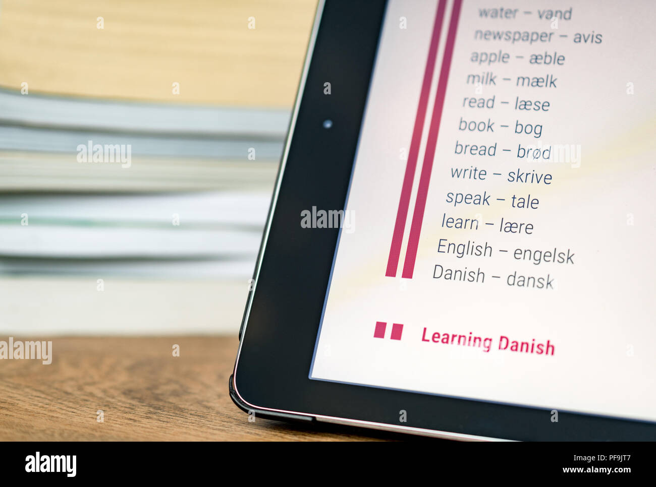 Learning Danish using a tablet with books in the background Stock Photo ...