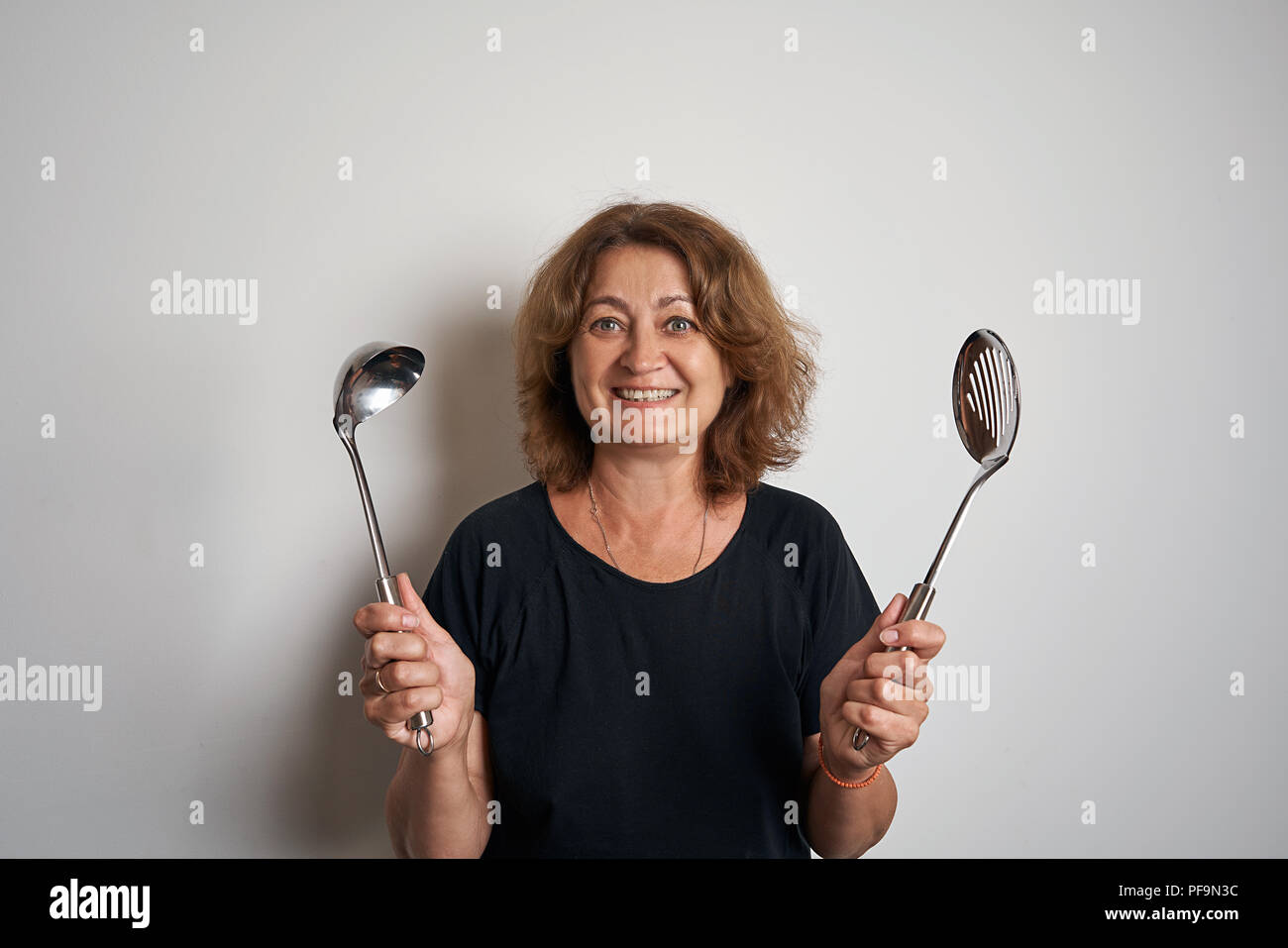 Kitchen woman cooking holding utensils hi-res stock photography and ...
