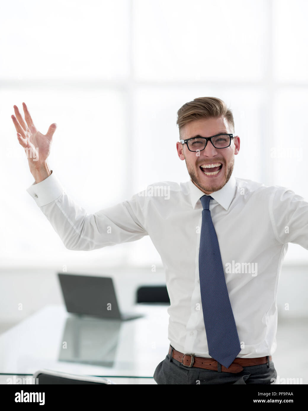 very happy businessman on office background Stock Photo - Alamy