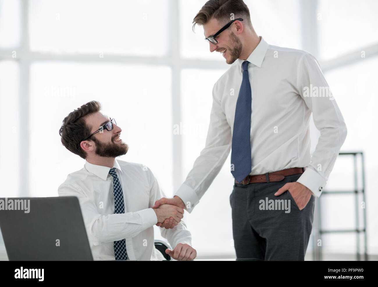 handshake employees in the workplace in the office Stock Photo - Alamy