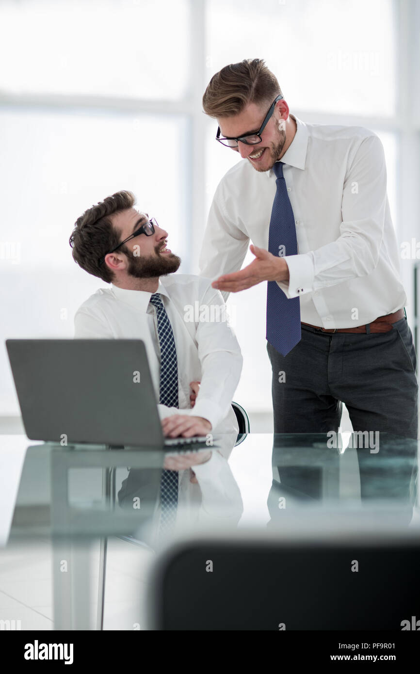 two employees discuss business issues near the office Desk Stock Photo ...