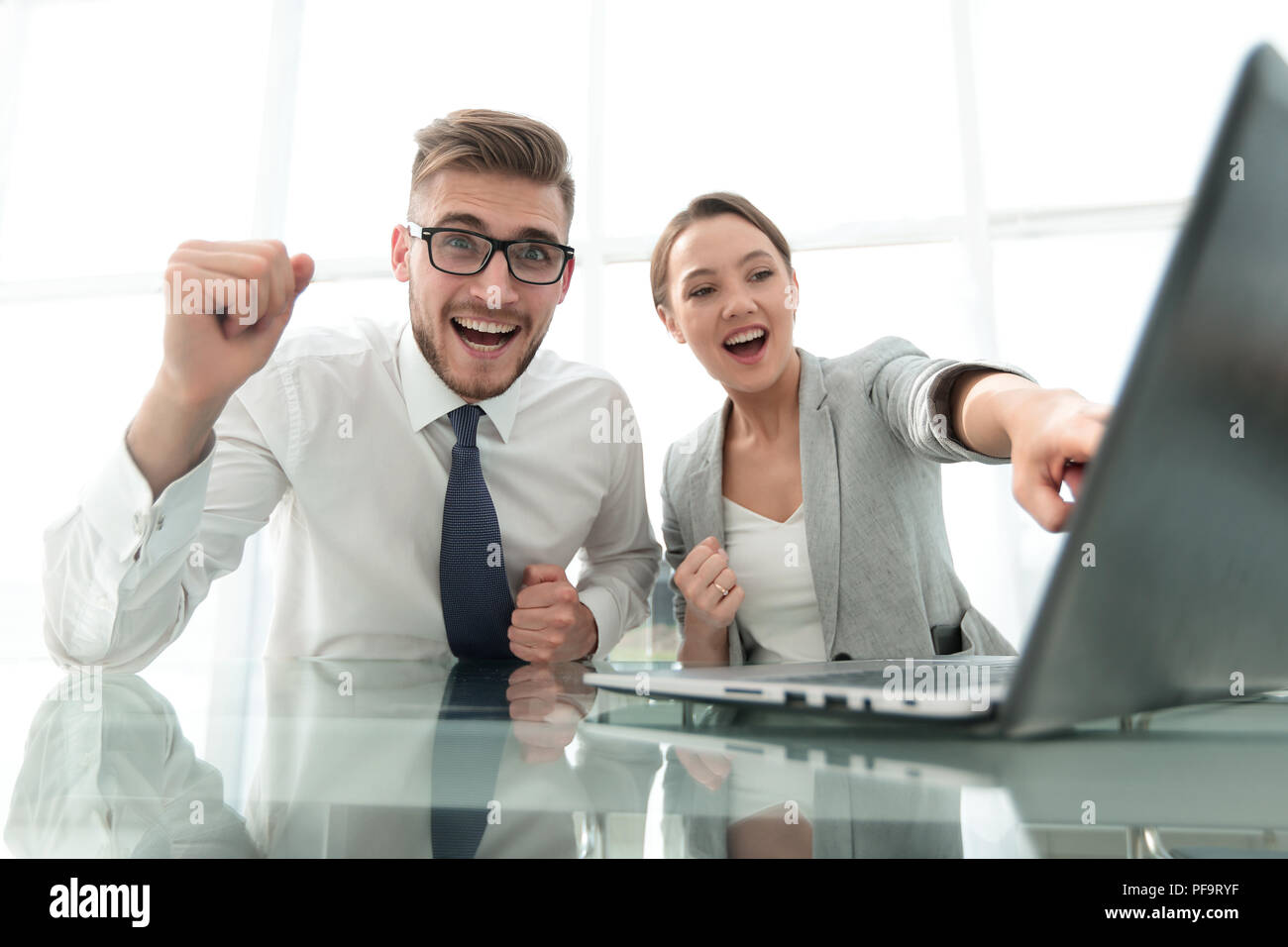 happy business colleagues sitting at their Desk Stock Photo - Alamy