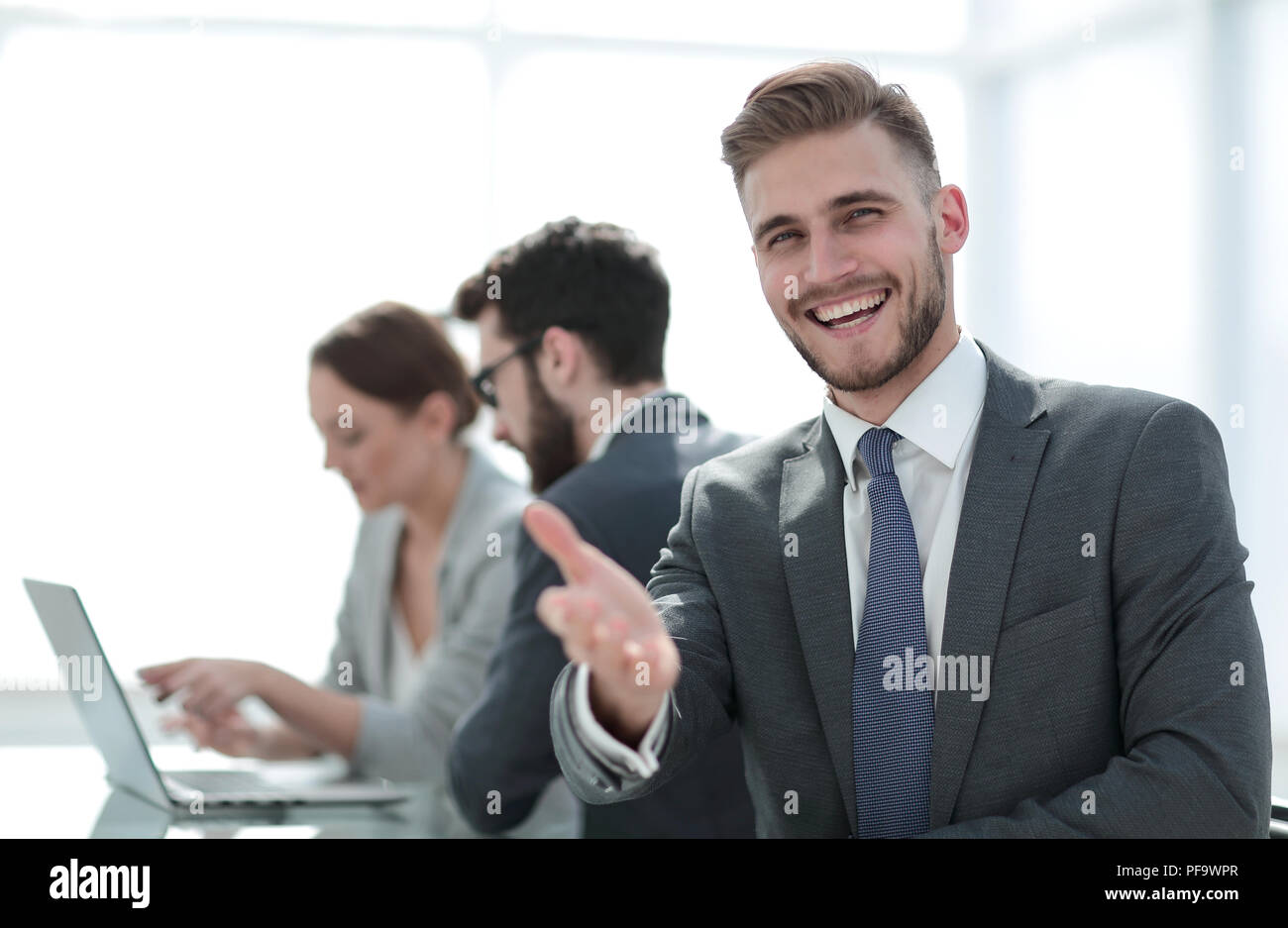 side view.successful businessman reaching out for a handshake Stock ...
