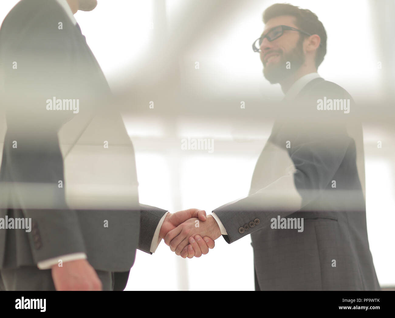 handshake is serious business partners Stock Photo - Alamy