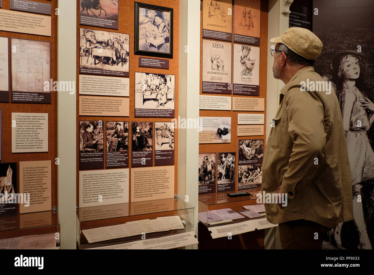 A visitor inspecting Schulz’s drawings displayed at a museum dedicated ...