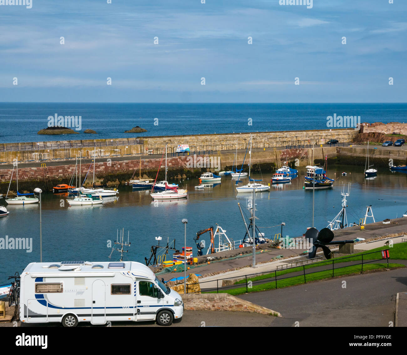 View of fishing boats in Dunbar harbour with parked motorhome, Dunbar ...
