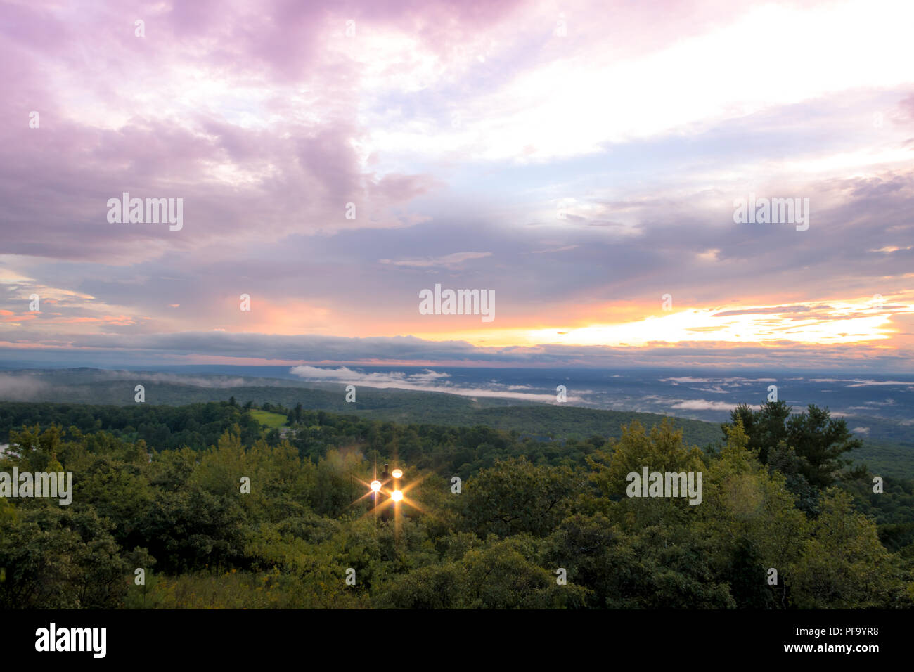 Fog lifts off the Kittatinny Mountains under a stormy sunset at High ...