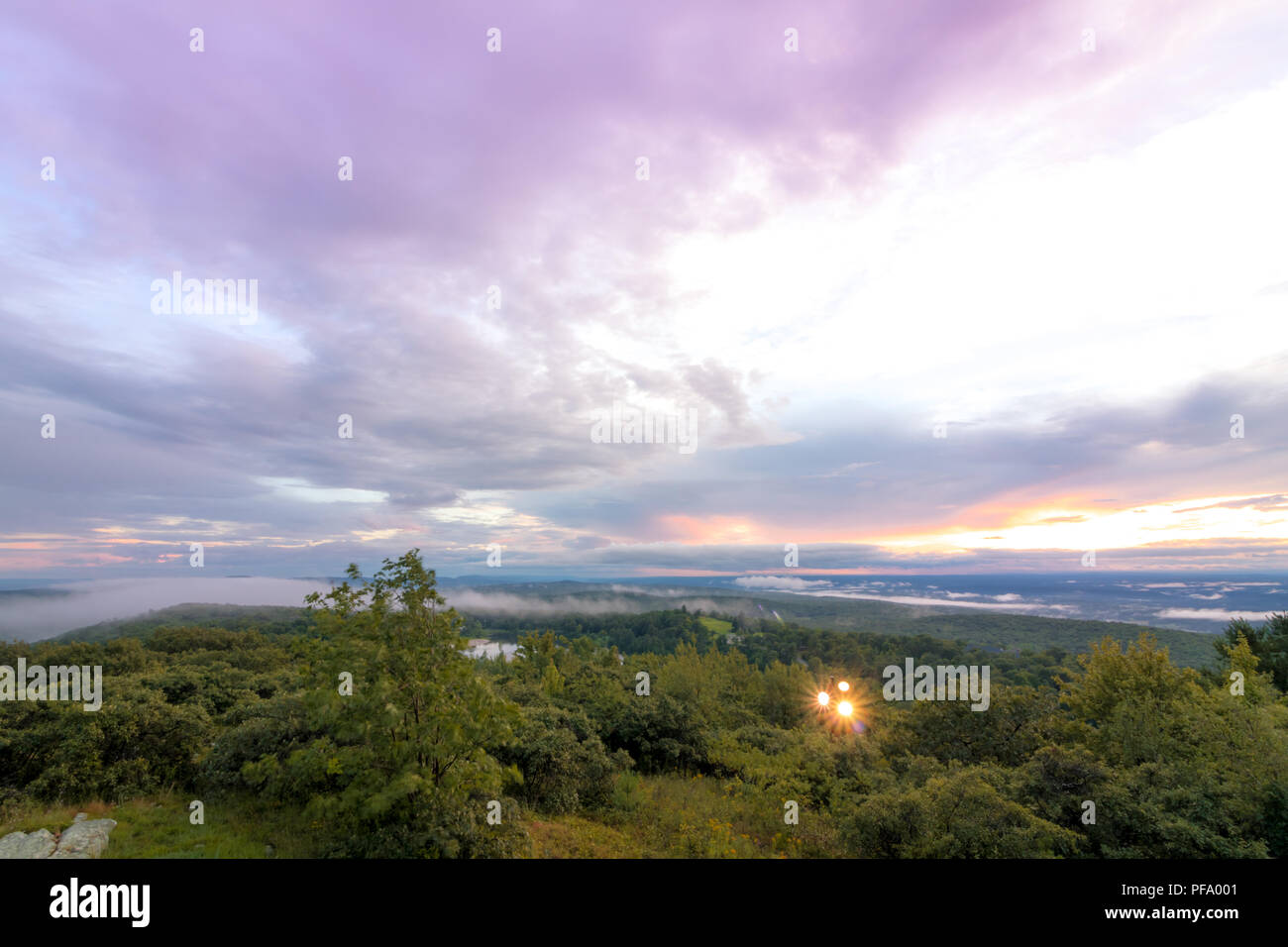 Fog lifts off the Kittatinny Mountains under a stormy sunset at High ...
