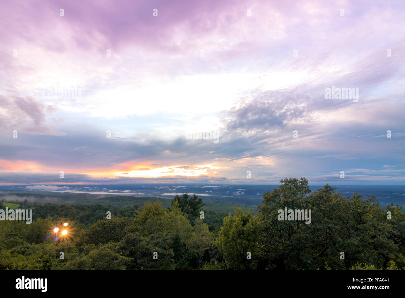 Fog lifts off the Kittatinny Mountains under a stormy sunset at High ...
