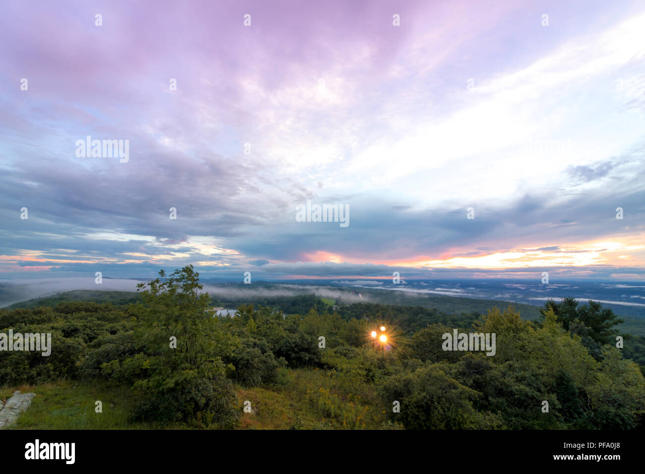 Fog lifts off the Kittatinny Mountains under a stormy sunset at High ...