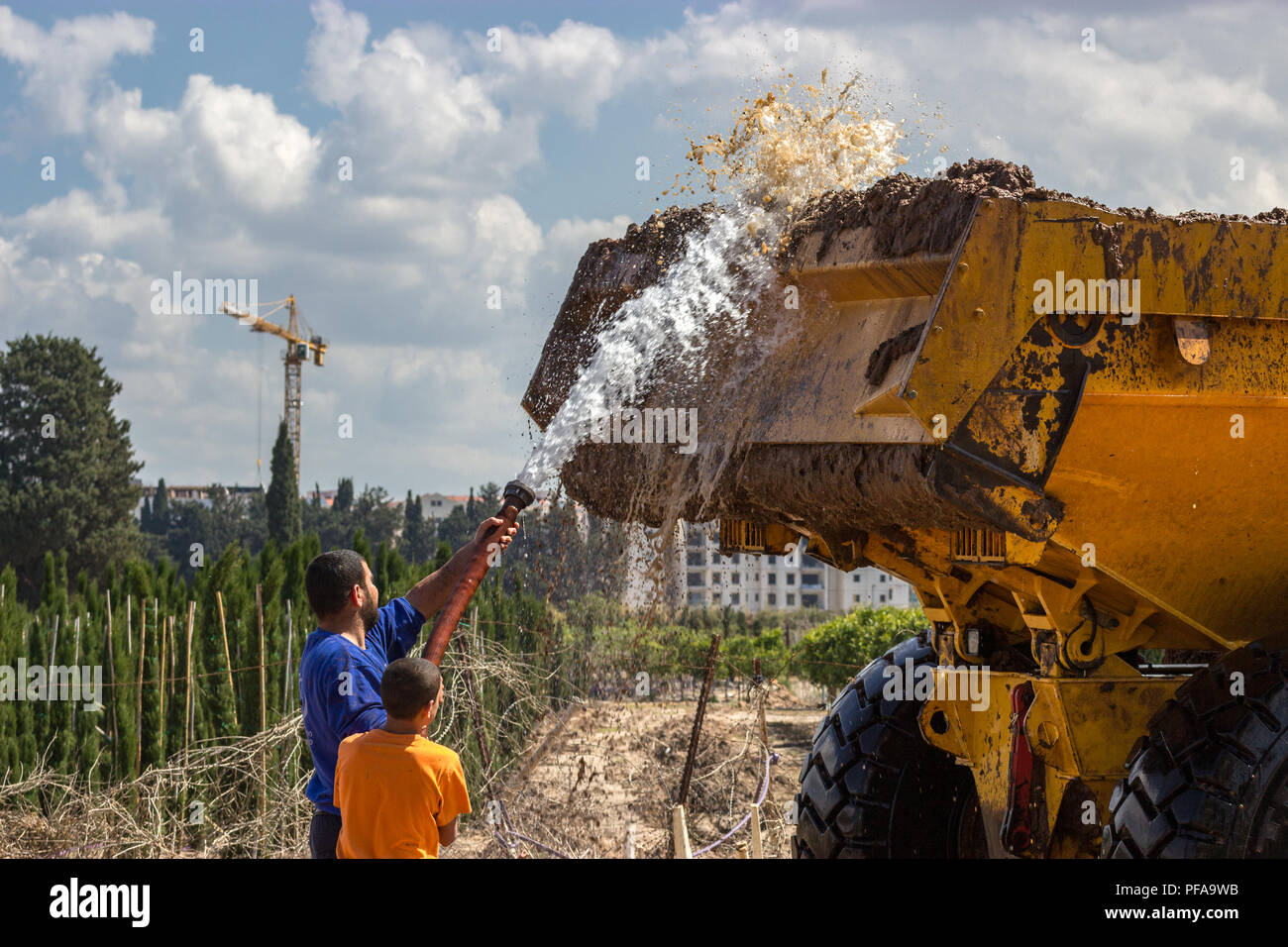 Cleaning big dump truck after working day Stock Photo - Alamy