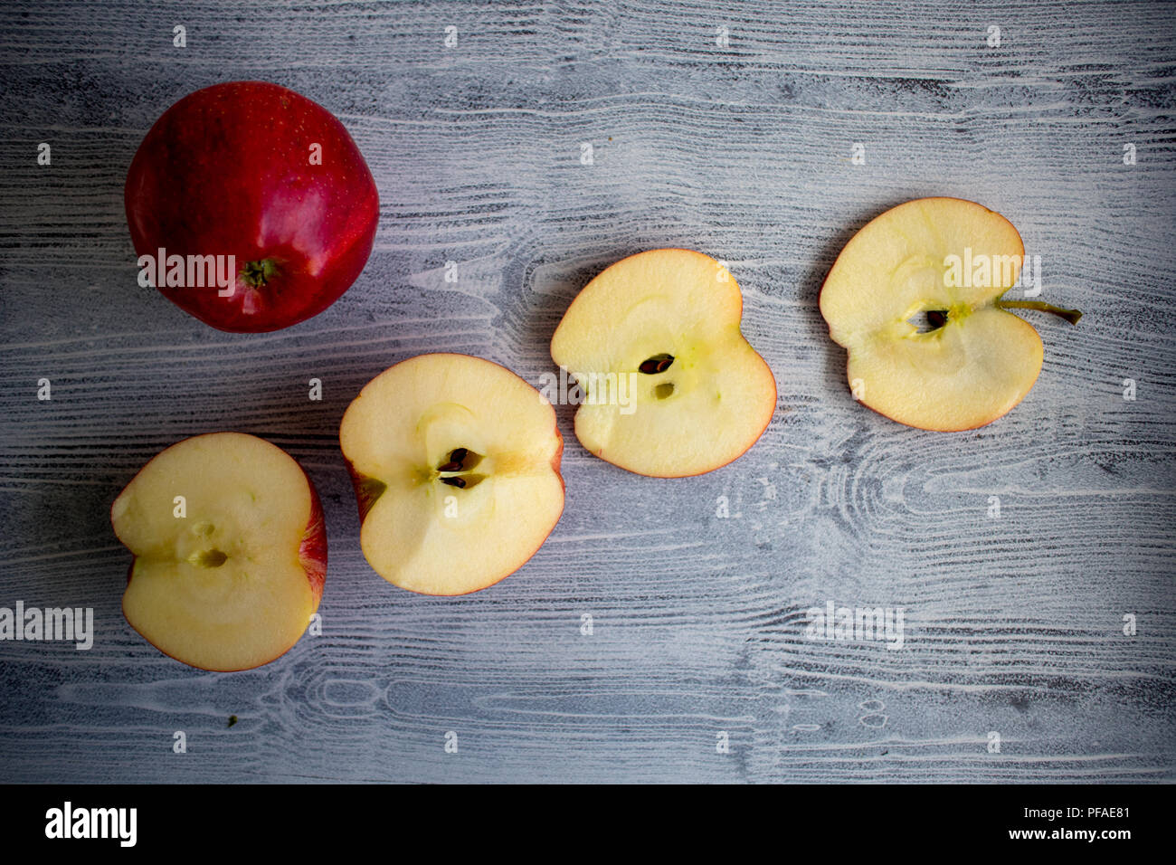 an isolated red apple and two half apples on a white background Stock ...