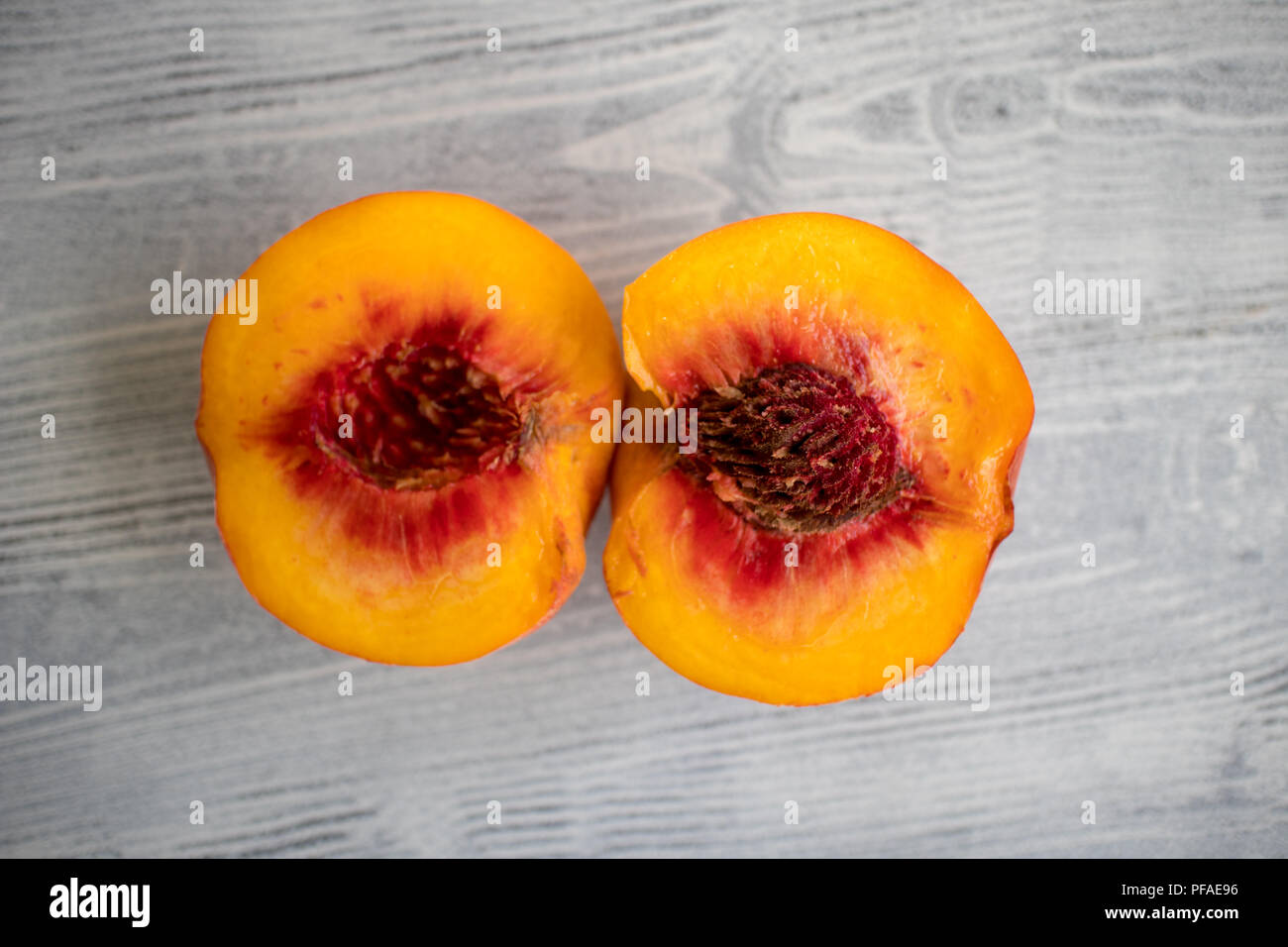 two half peaches on a white background Stock Photo - Alamy