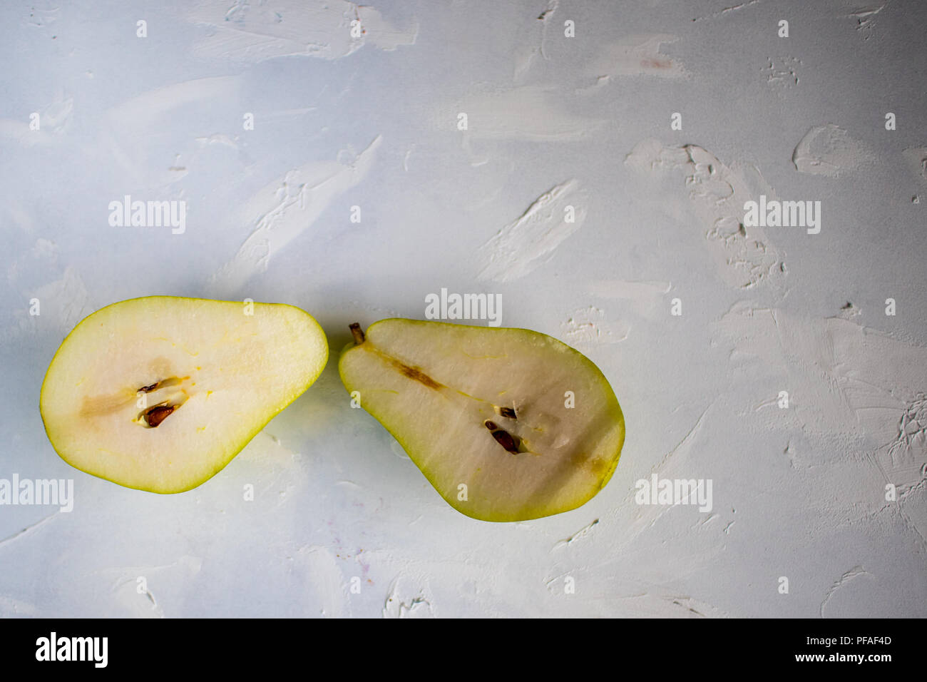 two half pears on a white background Stock Photo - Alamy