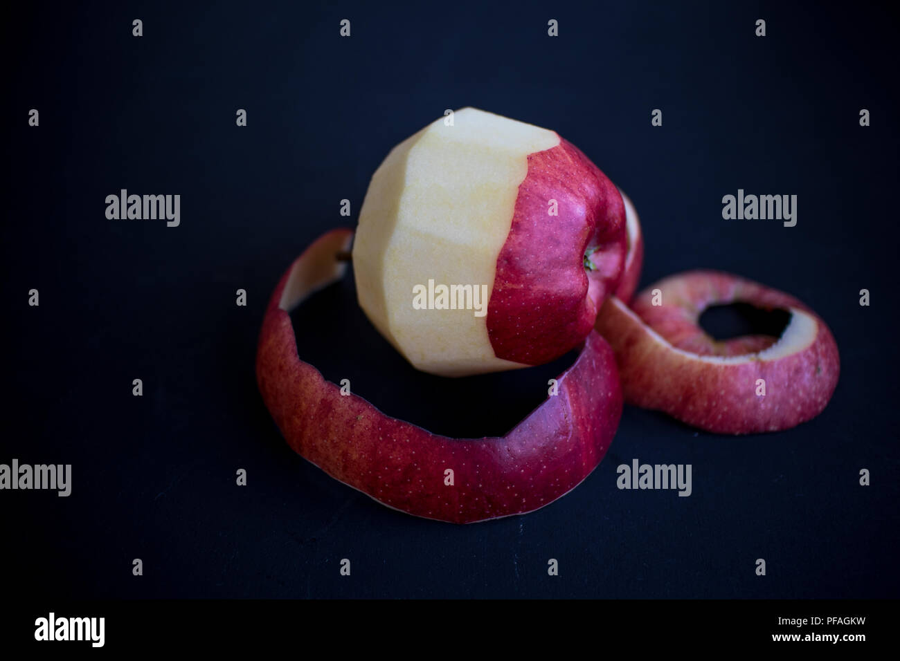 A peeled red apple isolated over a black background Stock Photo - Alamy